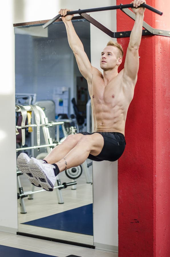 Young Man in Gym Hanging Upside-down To Exercise Abs Stock Image ...