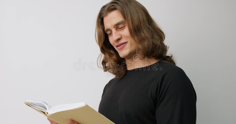 Young Man Has Fun while Reading a Book Stock Footage - Video of college ...