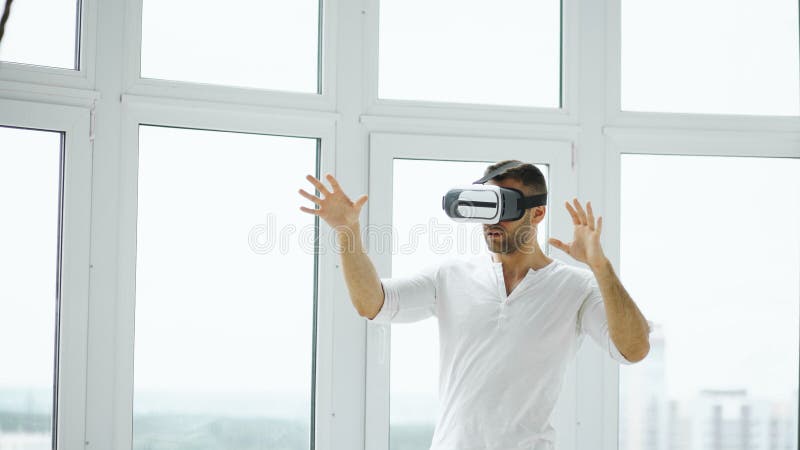Young Man Have VR Experience with Virtual Reality Headset Using Hands ...