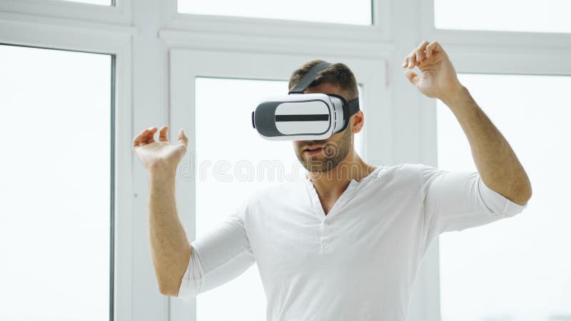 Young Man Have VR Experience with Virtual Reality Headset Using Hands ...
