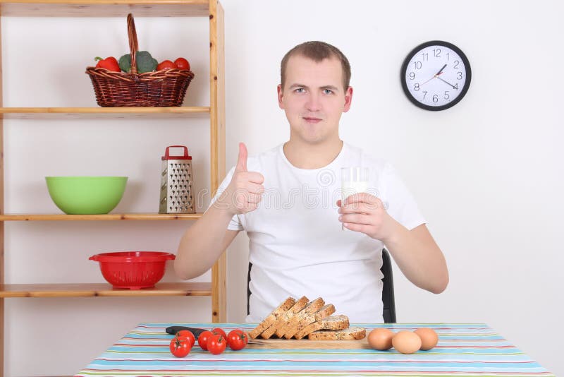 Young Man Having Breakfast in the Kitchen Stock Image - Image of person ...
