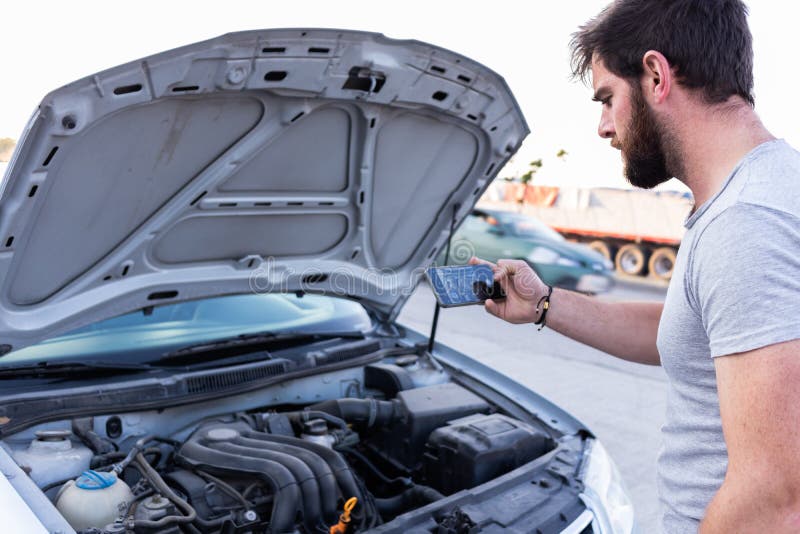 Young Man Having Car Engine Problems on the Road Calling Asking for ...