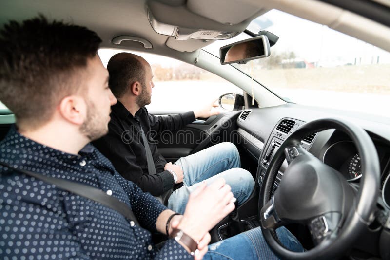 Young Man Having Driving Lesson with Male Instructor Stock Image ...
