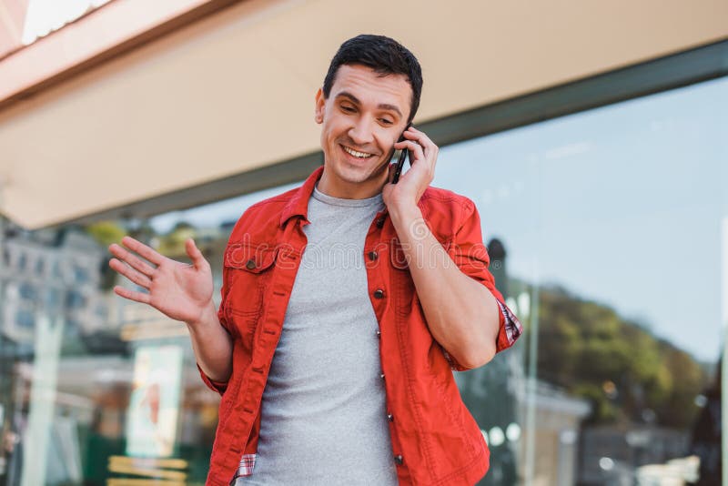 Young Man Having an Emotional Phone Conversation Stock Photo - Image of ...