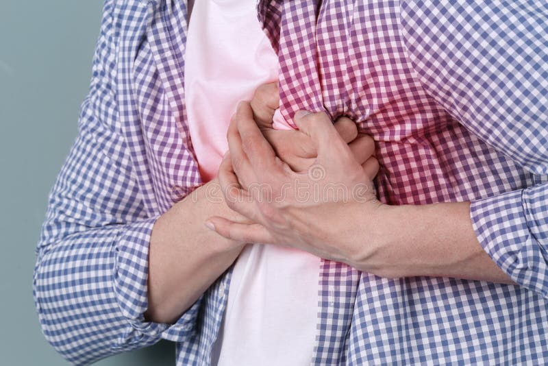Young Man Having Heart Attack Stock Photo - Image of male, medical ...