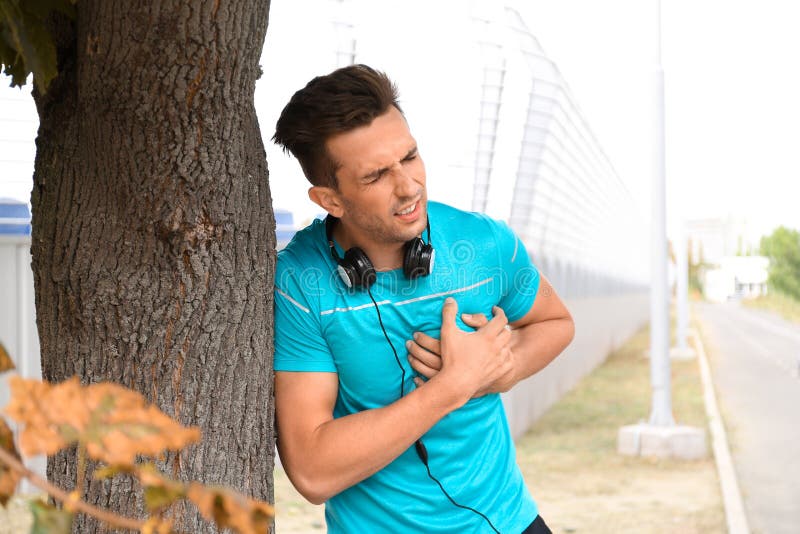 Young Man Having Heart Attack while Running Stock Image - Image of ...