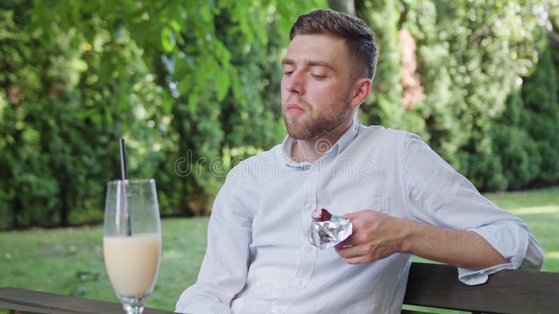 Young Man Having a Snack in the Park Stock Photo - Image of glass ...