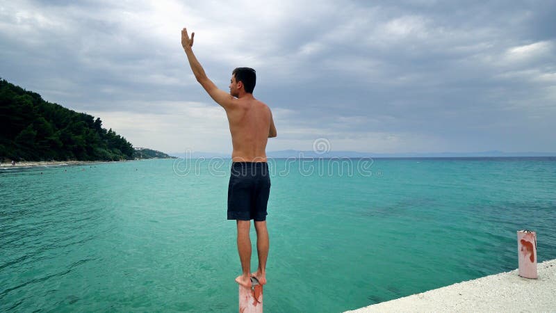 Young Men Having Speech Standing on Post at Pier on Empty Beach Stock ...