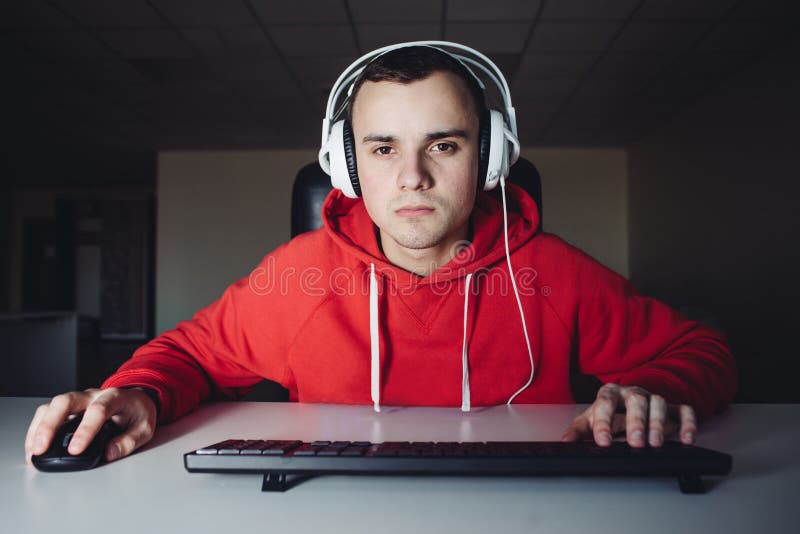 Young Man in Headphone Uses a Computer. Gamer Plays Games on the ...