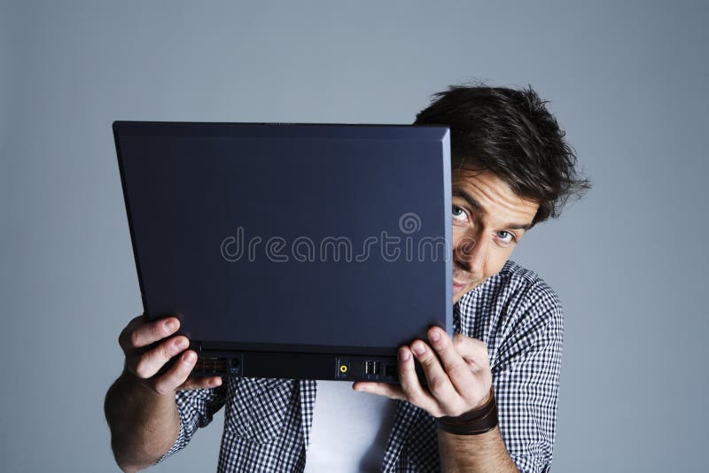 Young Man Hiding Behind Laptop Computer Stock Photo - Image of holding ...