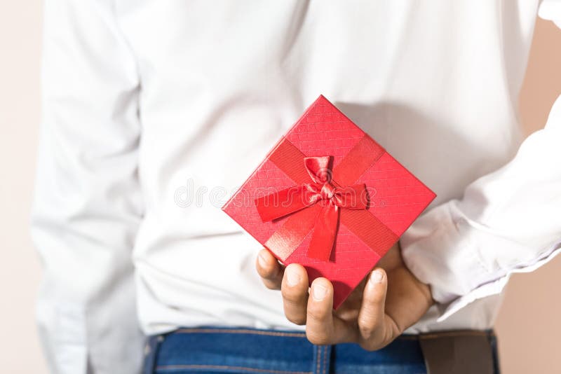 Young Man Hiding Red Gift Box Behind His Back Stock Image - Image of ...
