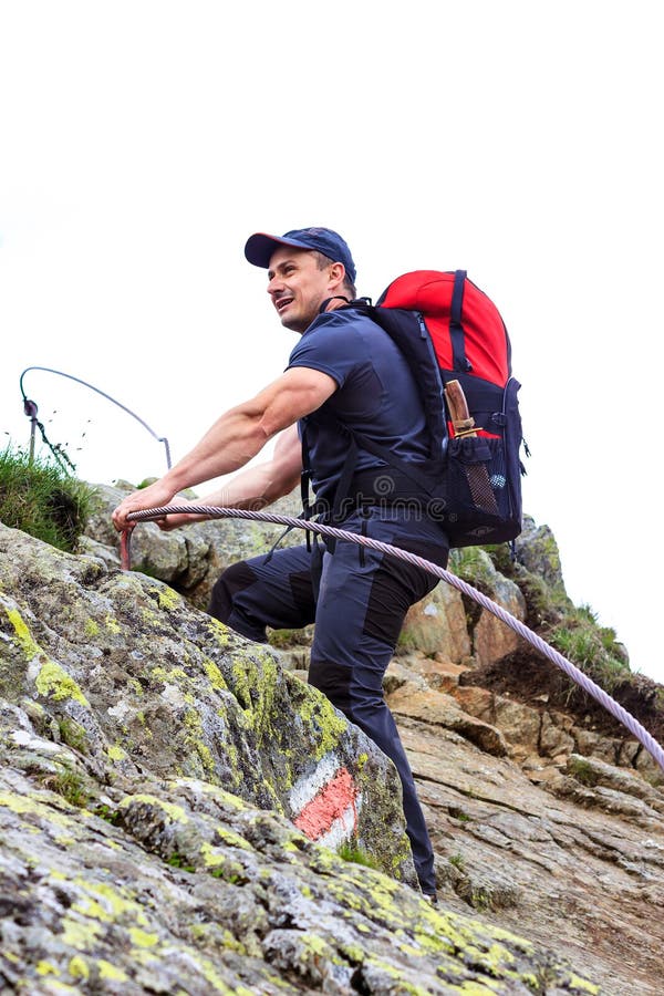 Young Man Hiking on Difficult Mountain Trail with Hanging Cable Stock ...
