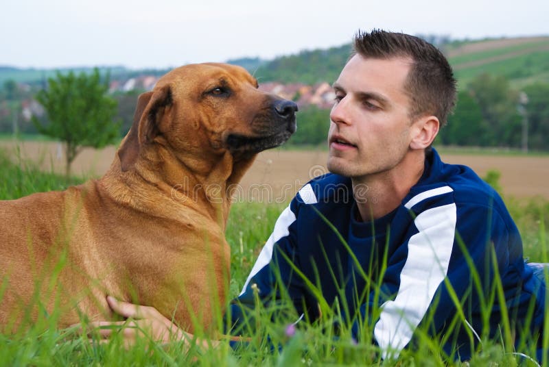 Young man and his dog stock photo. Image of active, friendship - 15995554