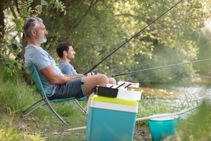 Young Man and Father Fishing on River Stock Image - Image of sitting ...
