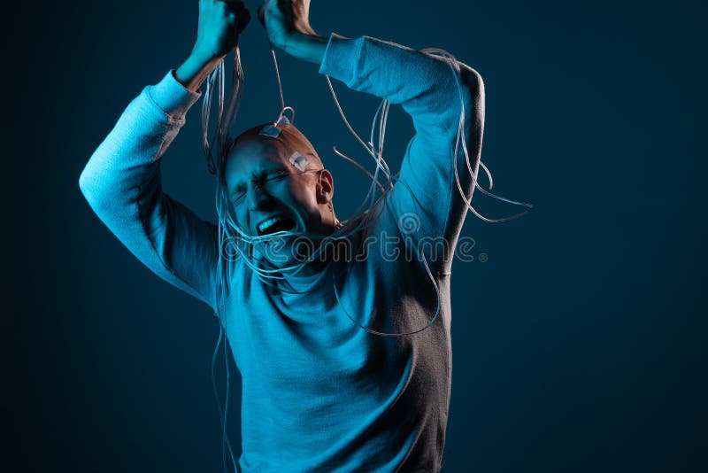 A Young Man with His Head Entangled in Wires is Trying To Pull Out ...