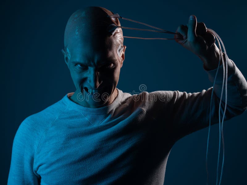 A Young Man with His Head Entangled in Wires is Trying To Pull Out ...