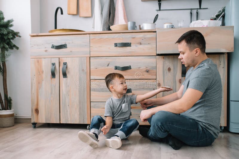 Young Man and His Son with Oven Sheet in Kitchen. Father with Little ...
