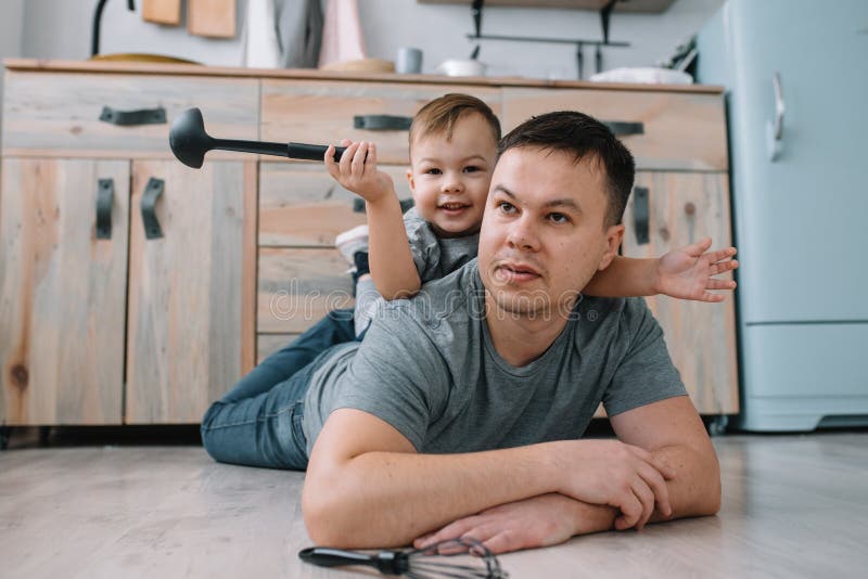 Young Man and His Son with Oven Sheet in Kitchen. Father with Little ...