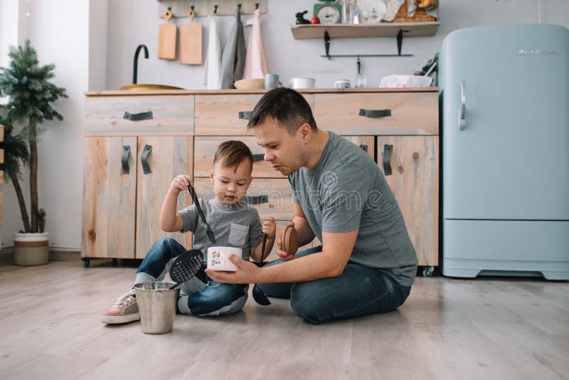 Young Man and His Son with Oven Sheet in Kitchen. Father with Little ...