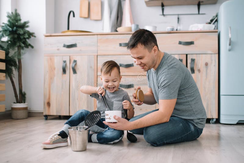 Young Man and His Son with Oven Sheet in Kitchen. Father with Little ...
