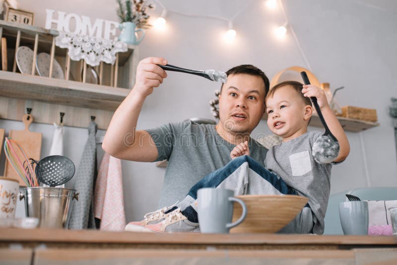 Young Man and His Son with Oven Sheet in Kitchen. Father with Little ...