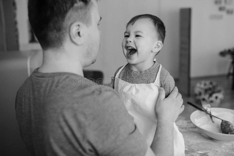 Young Man and His Son with Oven Sheet in Kitchen. Father with Little ...