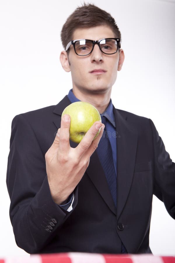 Young man holding an apple stock image. Image of apple - 26256007