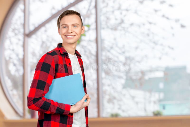 Young man holding books stock image. Image of education - 72929049