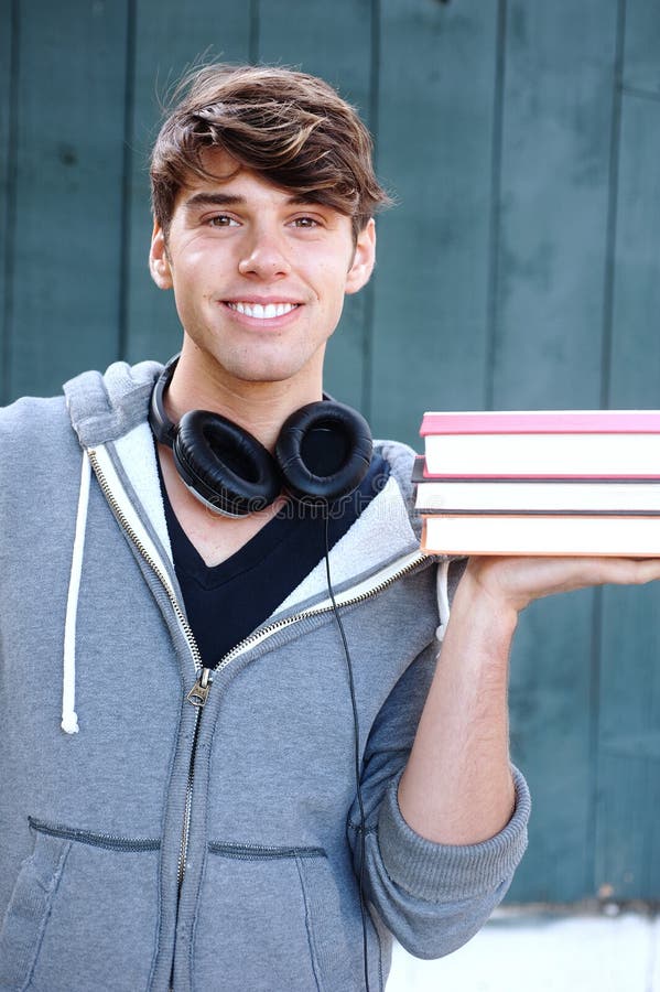 Young Man Holding Books Outside with Headphones Stock Photo - Image of ...