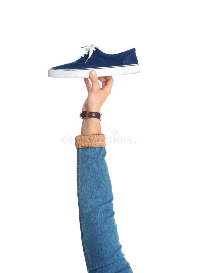 Young Man Holding Comfortable Shoe on White Backgroun Stock Photo ...