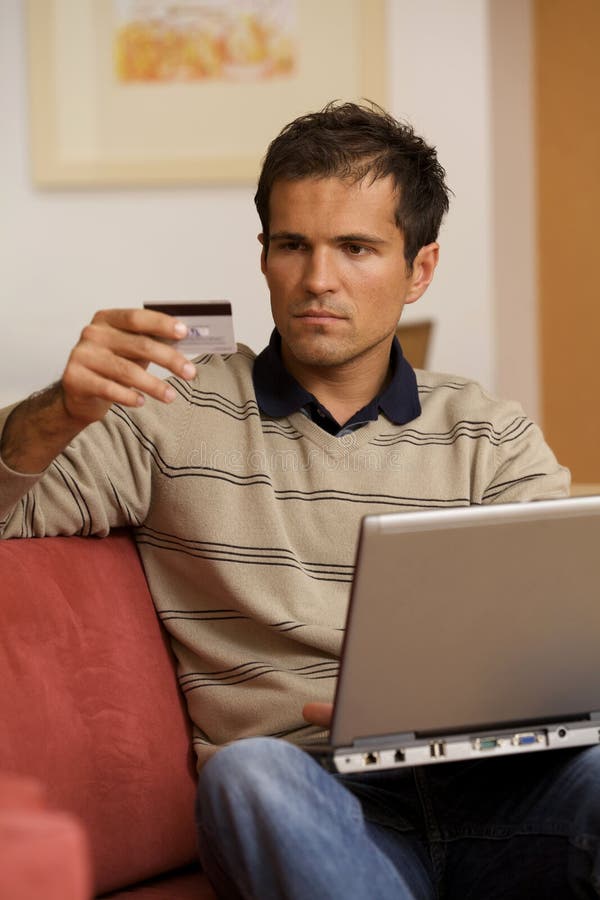 Young Man Holding Credit Card and Using Laptop Stock Photo - Image of ...