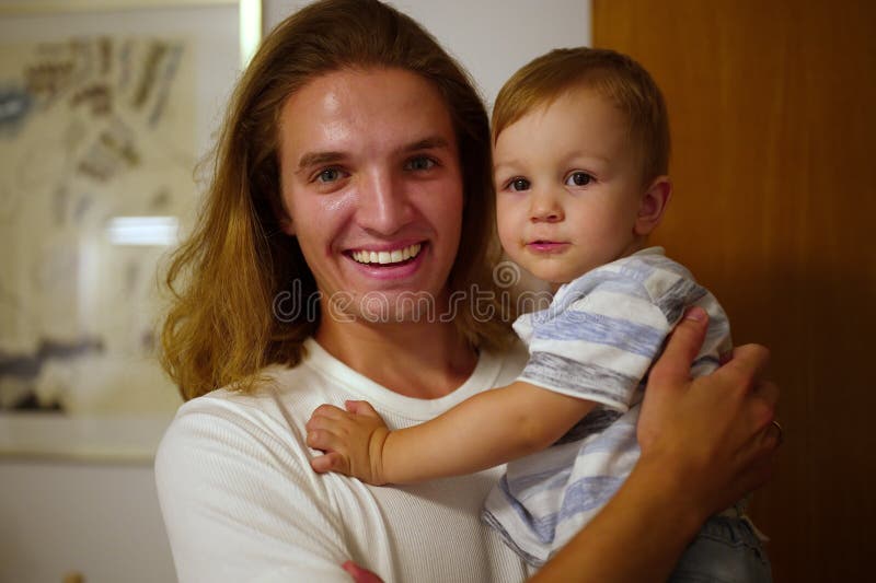 Young Man Holding Little Boy Stock Image - Image of little, adorable ...