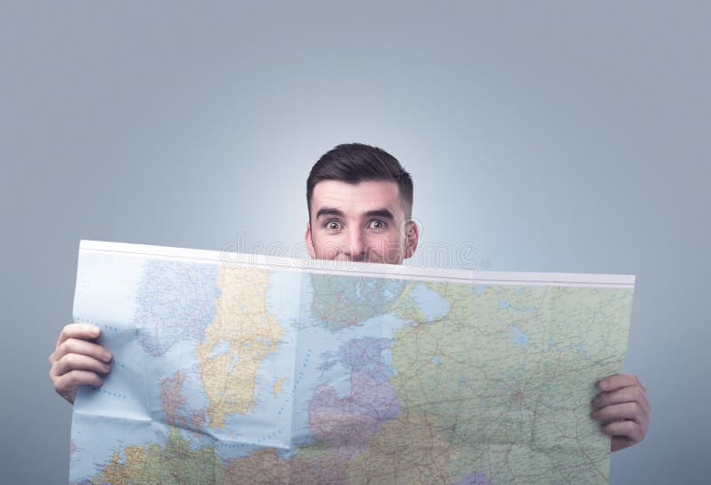 Young man holding map stock photo. Image of adventure - 95265520