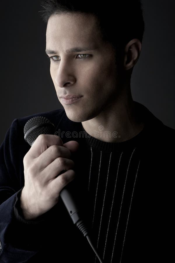 Young Man Holding Microphone Close-up Stock Image - Image of ...