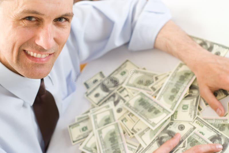 Young Man Holding Large and Small Money Stock Image - Image of ...