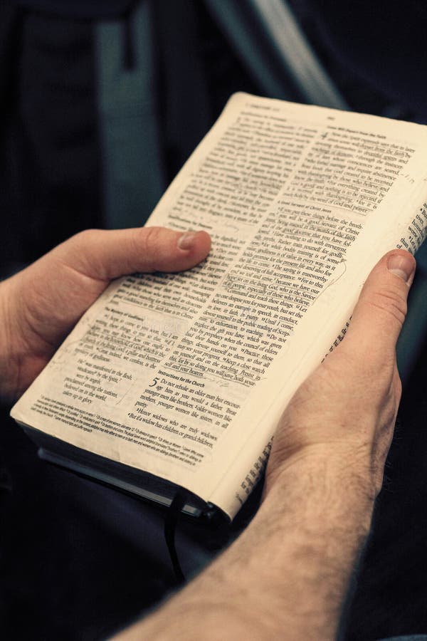 Young Man Holding an Open Bible, Reading and Taking Notes Stock Image ...