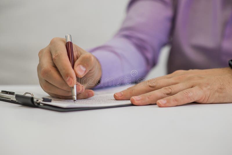 Young Man Holding a Pencil, Writing on a Paper in the Diary Stock Photo ...