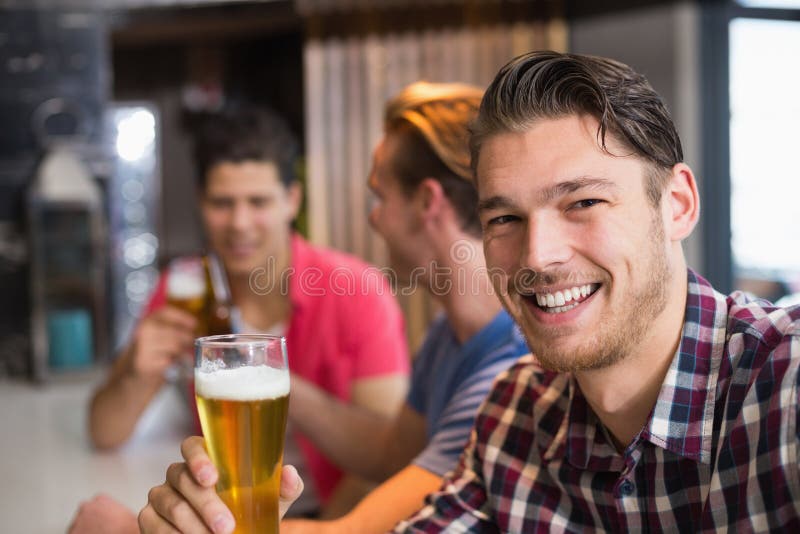 Young Man Holding Pint of Beer Stock Image - Image of looking ...
