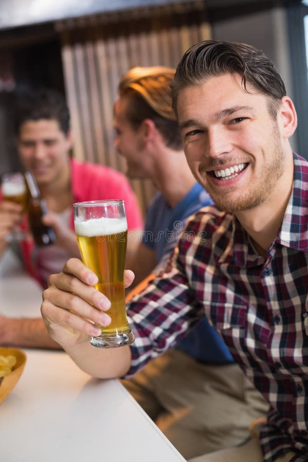 Young Man Holding Pint of Beer Stock Image - Image of casual, clothing ...
