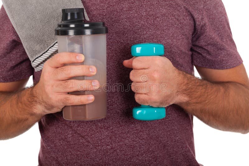 Young Man Holding a Protein Shake and a Dumbbell Stock Photo - Image of ...