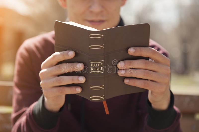Young Man Holding and Reading Holy Bible Editorial Photo - Image of ...
