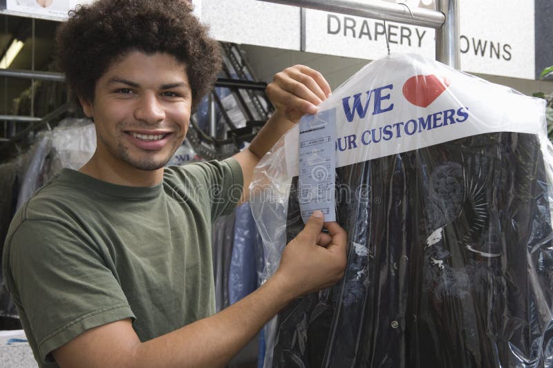 Young Man Holding Receipt in Dry Cleaning Store Stock Image - Image of ...