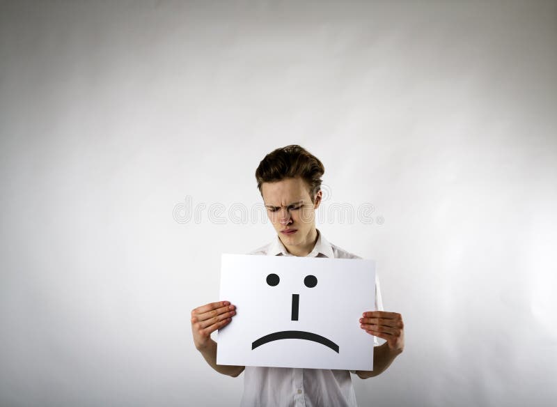 Young Man is Holding White Paper with Smile. Unhappy Man Stock Photo ...