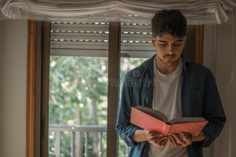 Young Man at Home Reading a Book Stock Photo - Image of home, young ...