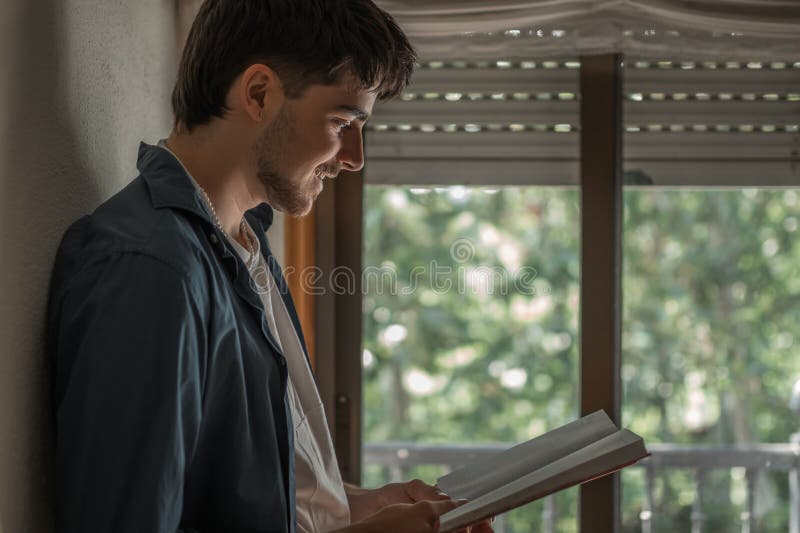 Young Man at Home Reading a Book Stock Photo - Image of home, natural ...