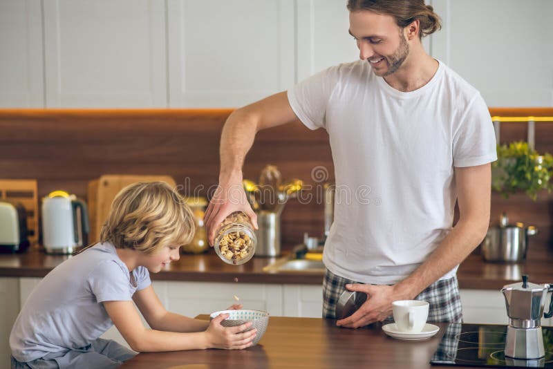 Young Man in Homewear Making Breakfast for His Son Stock Photo - Image ...