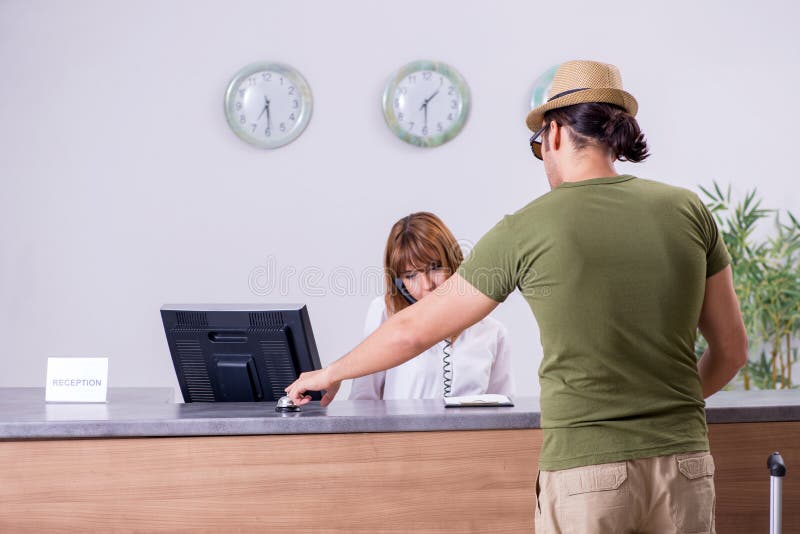 Young Man at the Hotel Reception Stock Photo - Image of desk, male ...