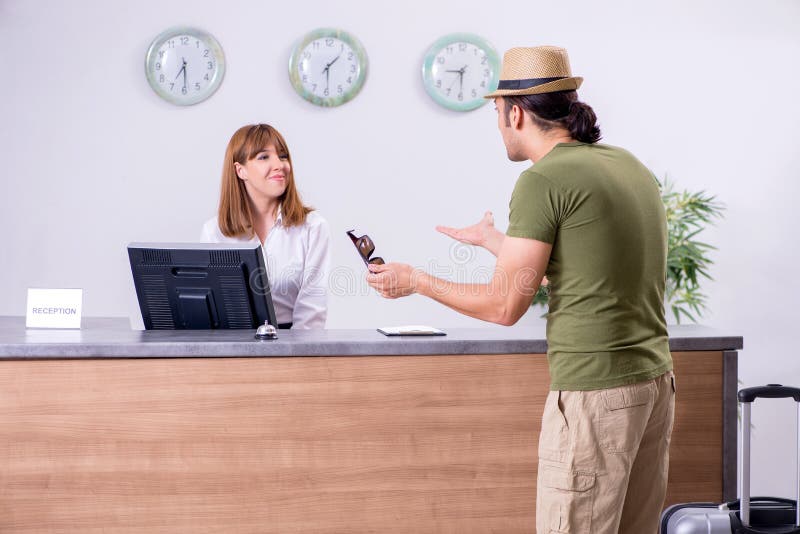 Young Man at the Hotel Reception Stock Photo - Image of cheerful ...