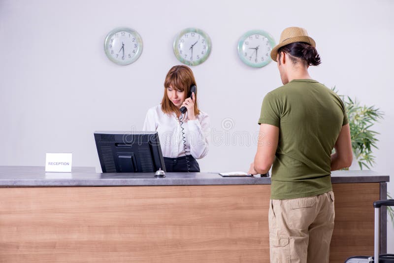 Young Man at the Hotel Reception Stock Image - Image of hotel, desktop ...