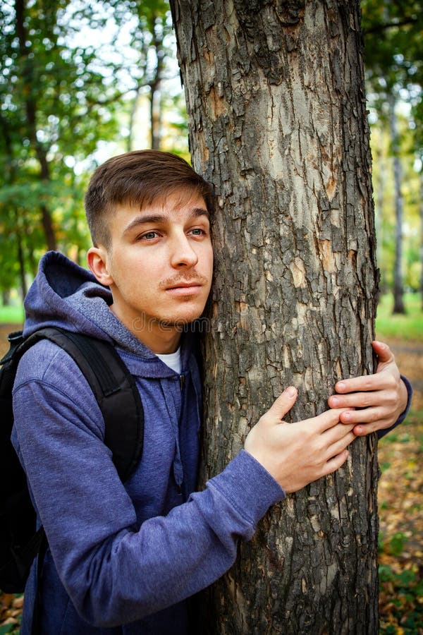 Young Man with a Tree stock photo. Image of outdoor - 195692734